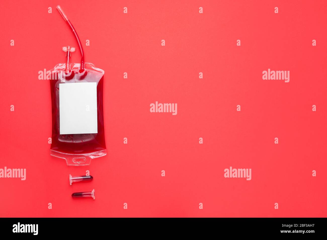 Blood pack for transfusion and test tubes on color background Stock ...