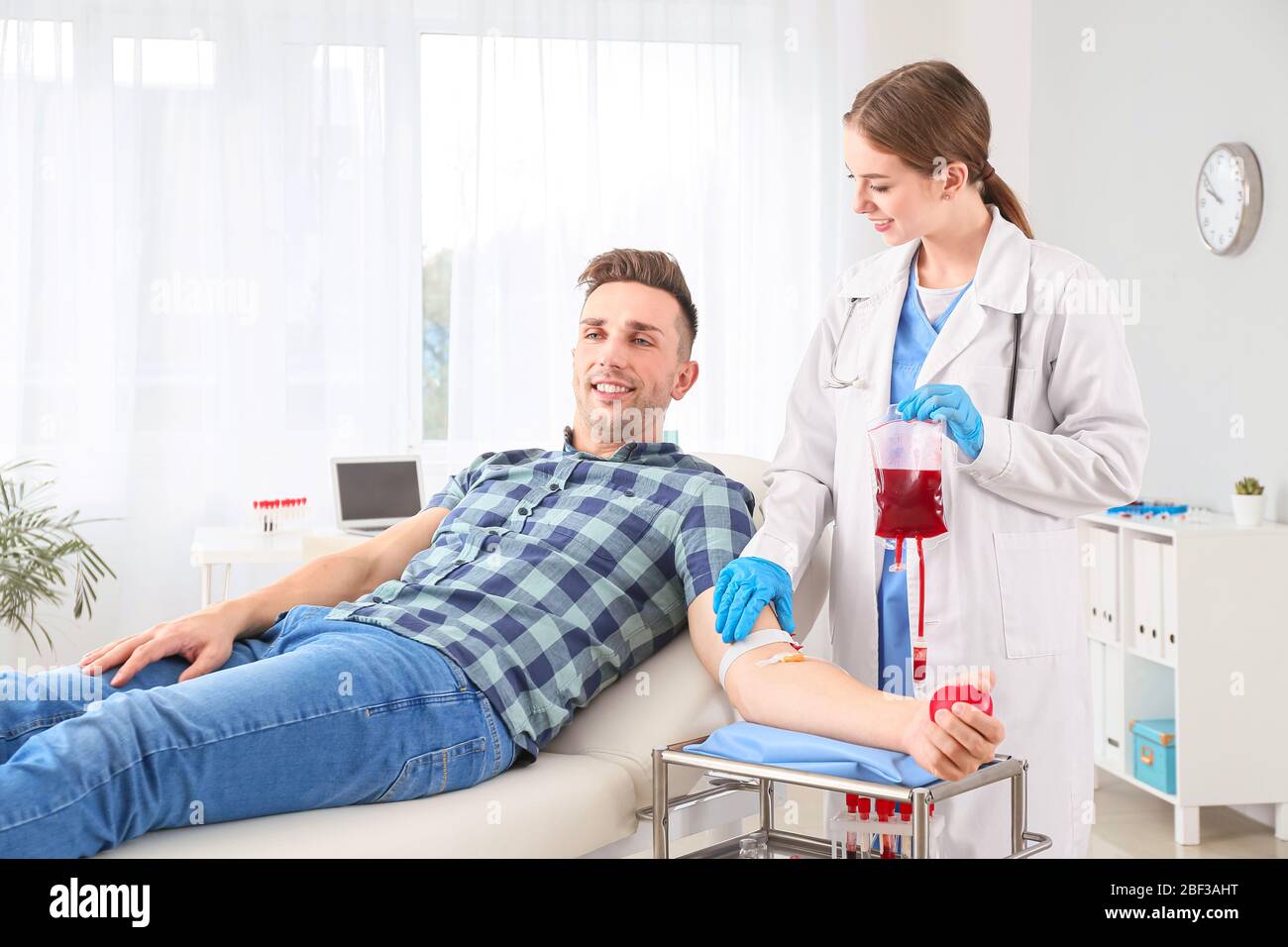 Man donating blood in hospital Stock Photo - Alamy