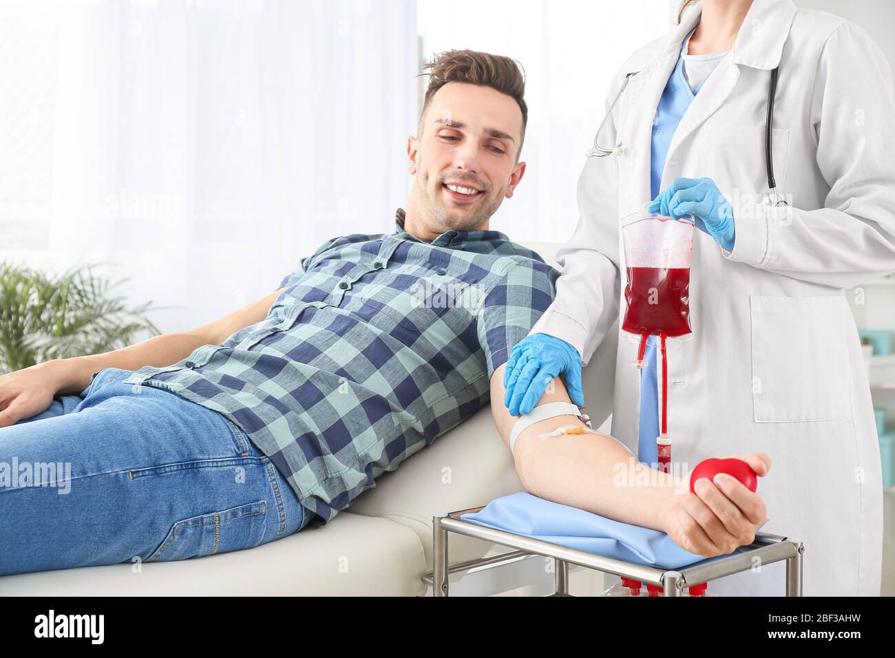 Man donating blood in hospital Stock Photo - Alamy
