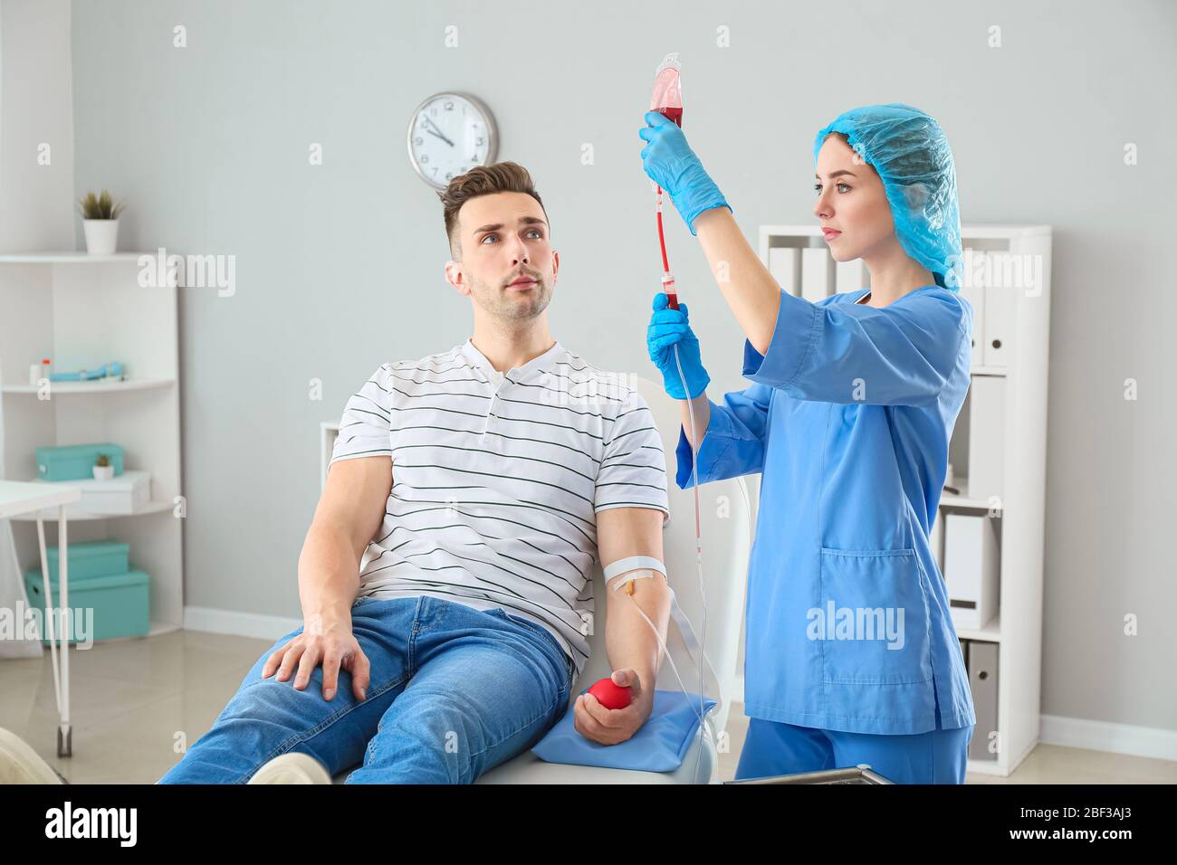 Man donating blood in hospital Stock Photo - Alamy