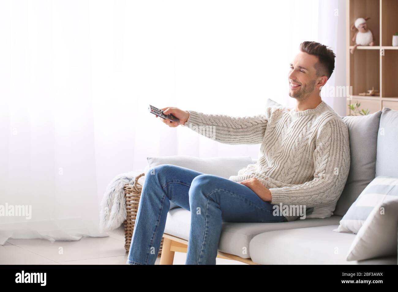 Happy man watching TV at home Stock Photo - Alamy