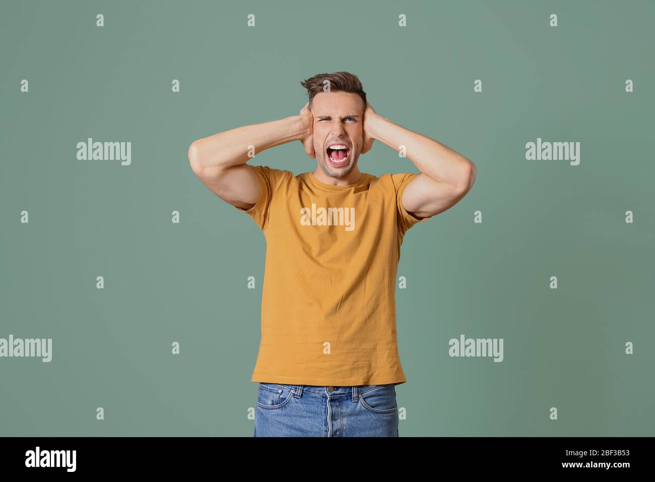 Man covering ears green hi-res stock photography and images - Alamy