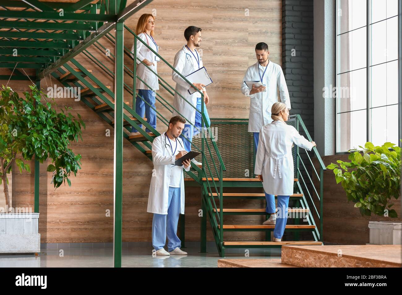 Doctors in corridor of modern clinic Stock Photo - Alamy