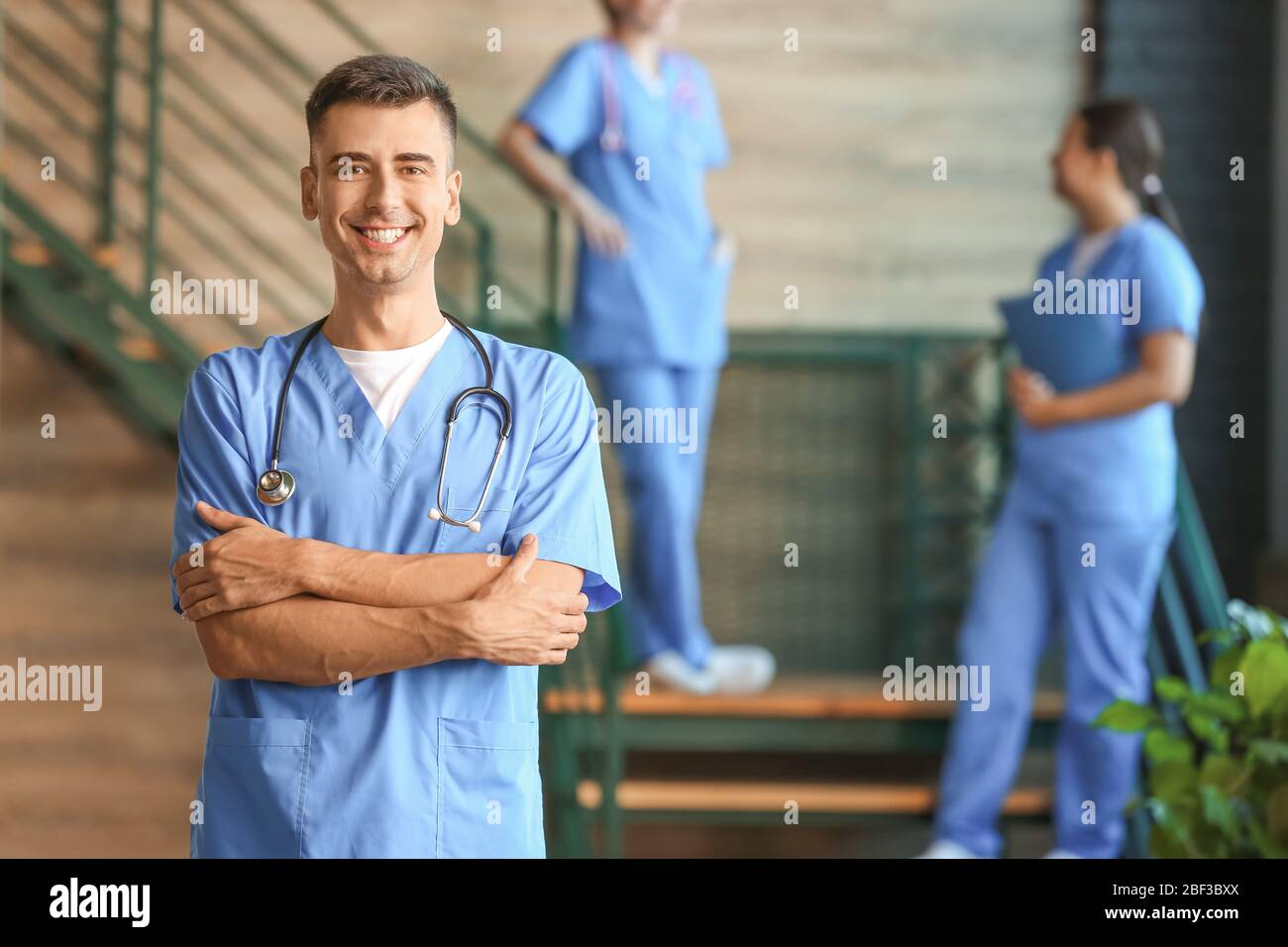 Male medical student in corridor of modern clinic Stock Photo - Alamy