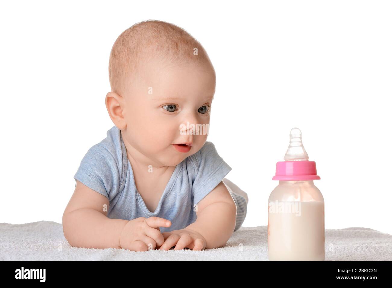 Portrait of cute little baby with bottle of milk on white background ...