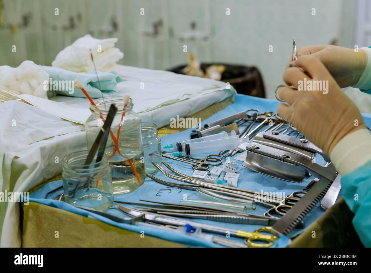 Close-up of scrub nurse taking medical tools for surgery Stock Photo ...