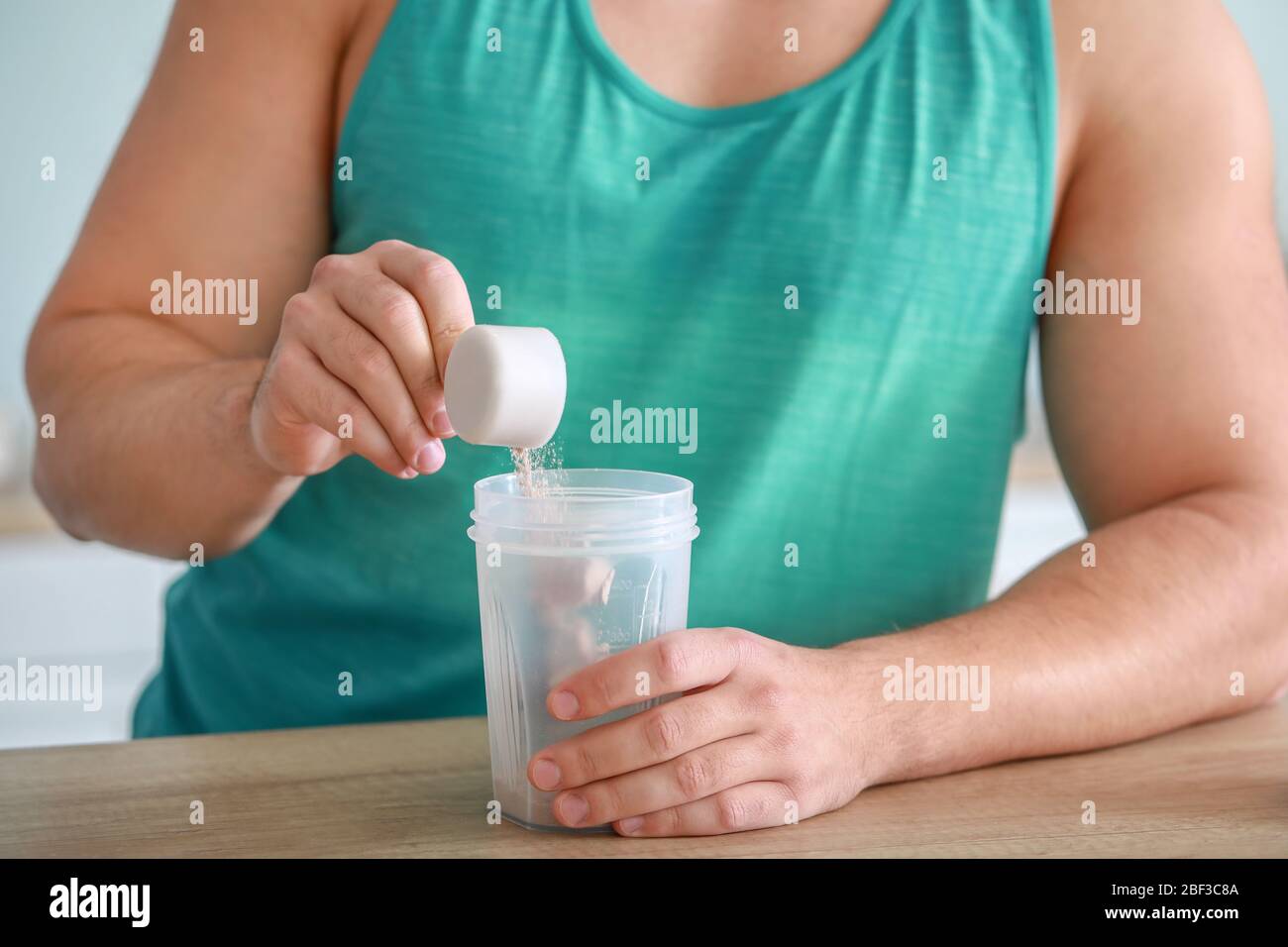 Sporty man making protein shake at home, closeup Stock Photo - Alamy