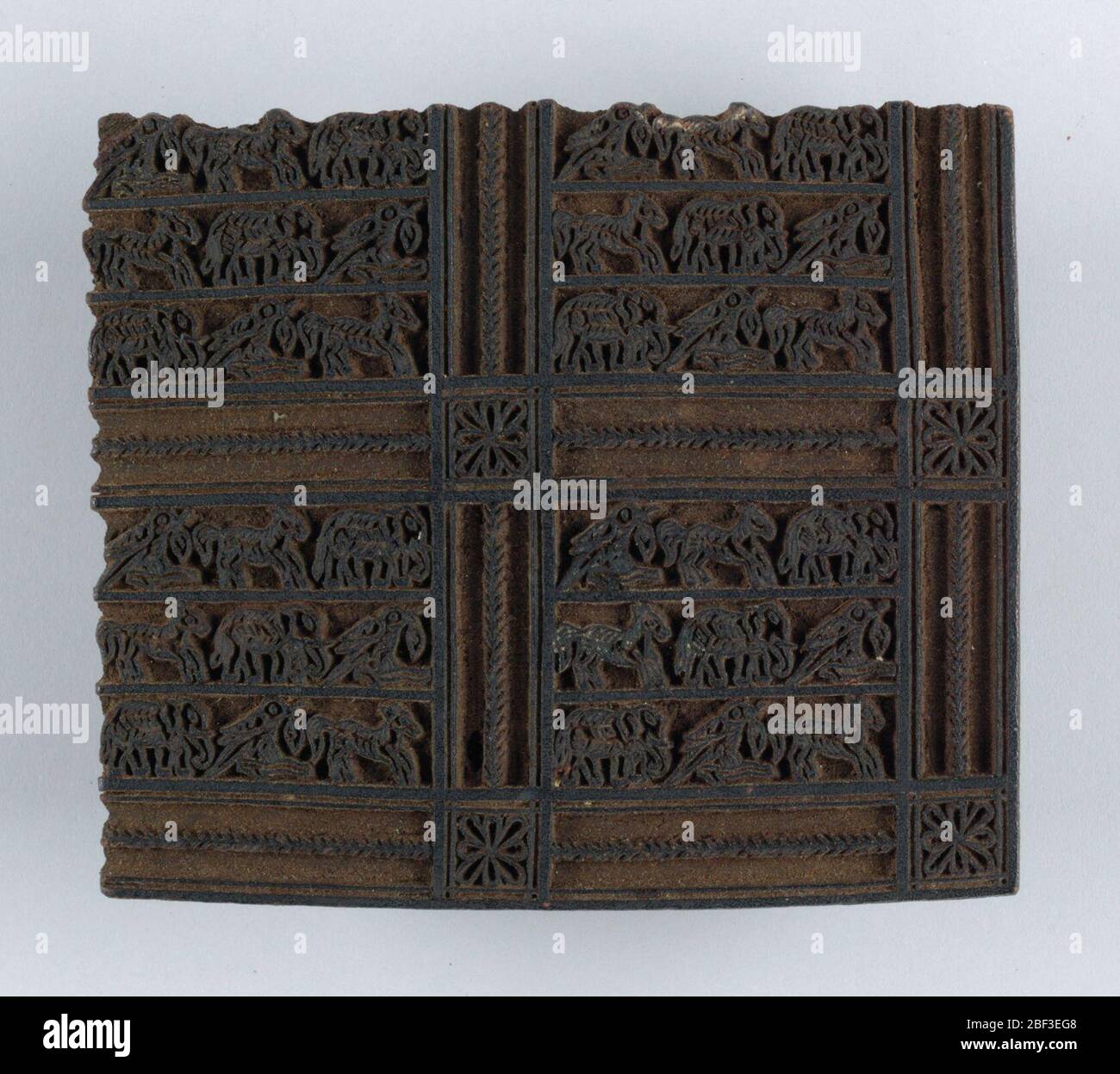 Printing block. Carved block design shows squares containing very small ...