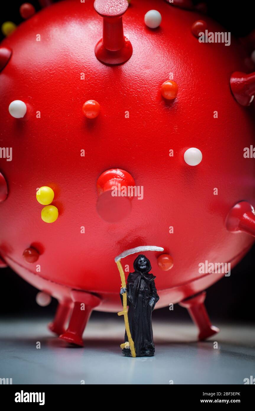 Grim reaper with red coronavirus model metaphor Stock Photo - Alamy