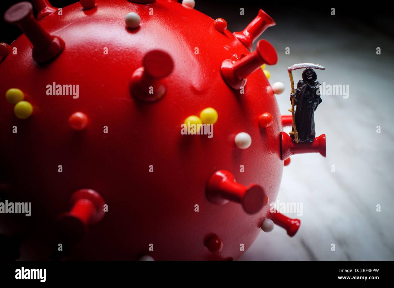 Grim reaper with red coronavirus model metaphor Stock Photo - Alamy