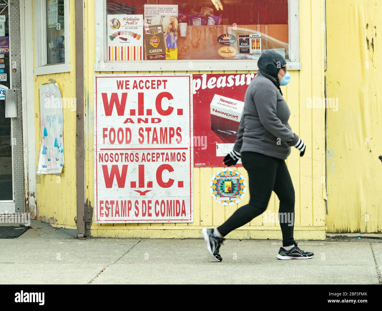 April 16, 2020, Chelsea, Massachusetts, USA: Woman walking by WIC food ...