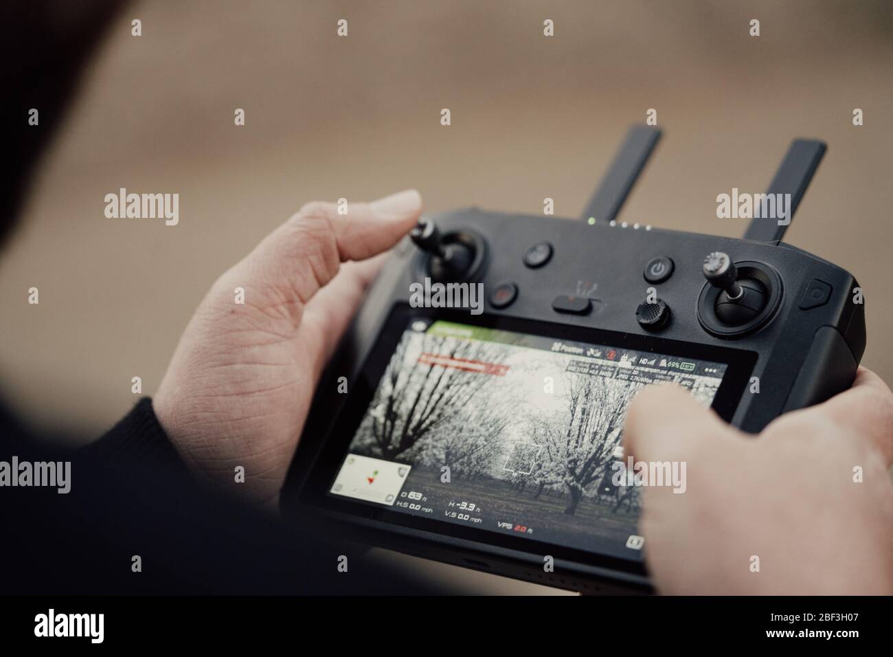 Drone smart controller being held and used in the field Stock Photo - Alamy