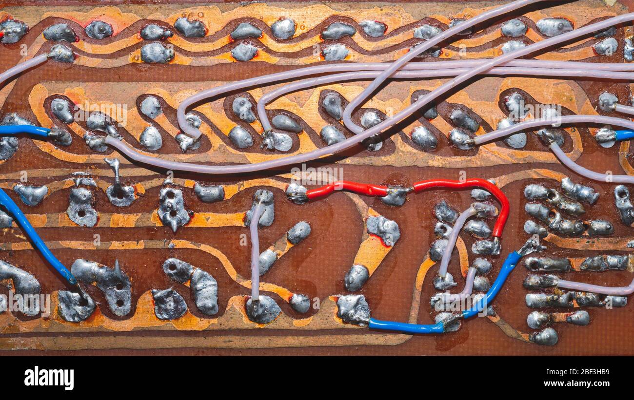 Handmade circuit board with connections and traces. colorful wires ...