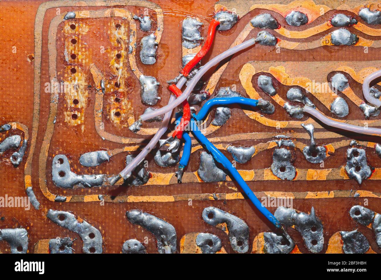 Handmade circuit board with connections and traces. colorful wires ...