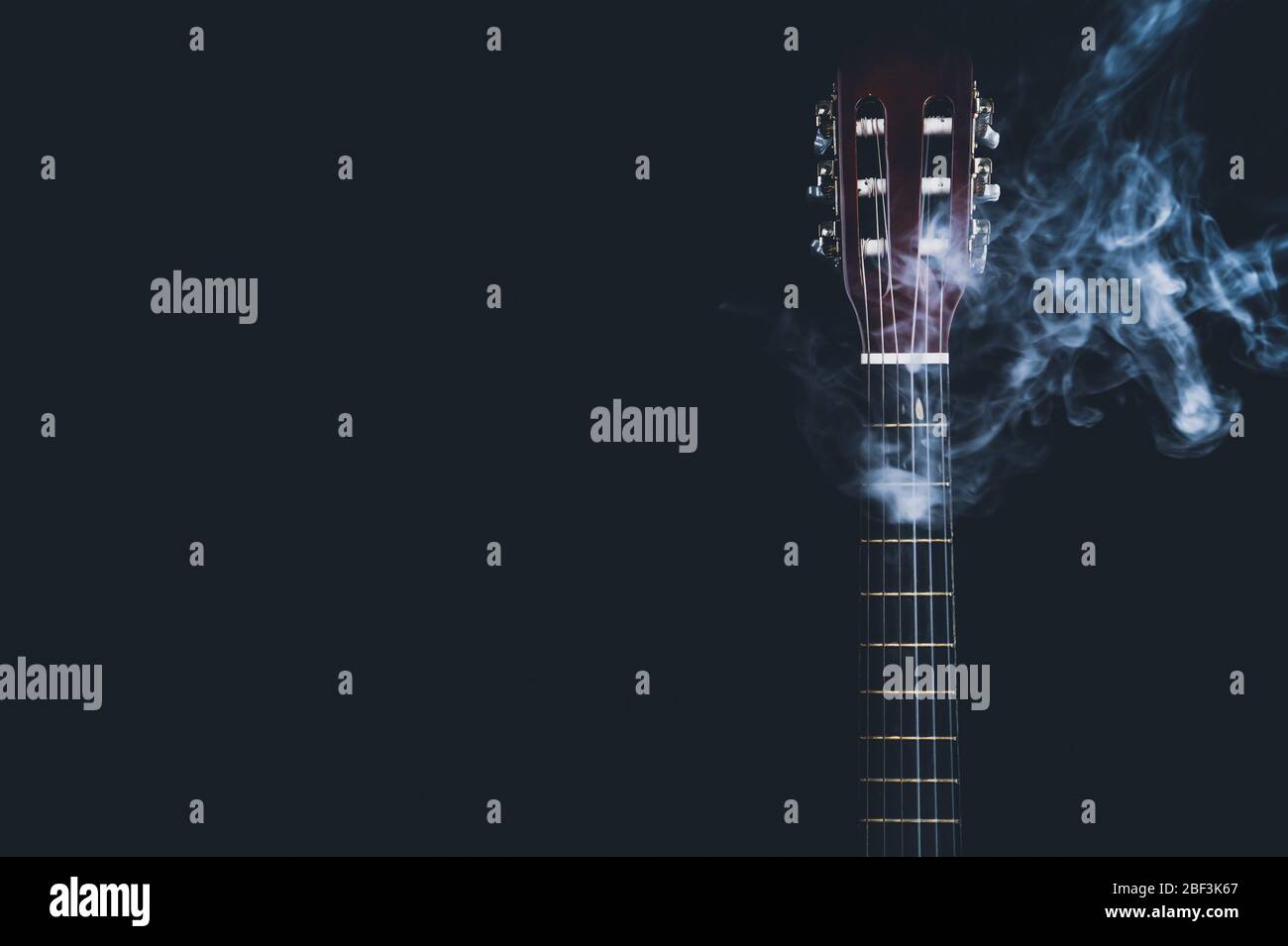 Guitar in smoke on the black background. acoustic musical instrument ...