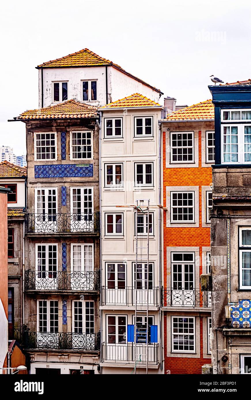 Tall colorful buildings with balconies and azulejo tiles in Porto ...