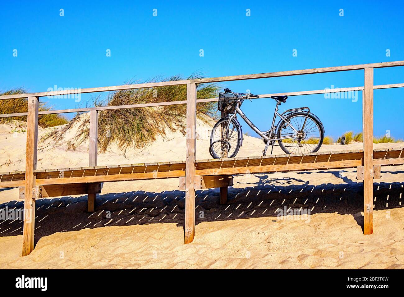 Bike on a beach boardwalk above the sand Stock Photo - Alamy