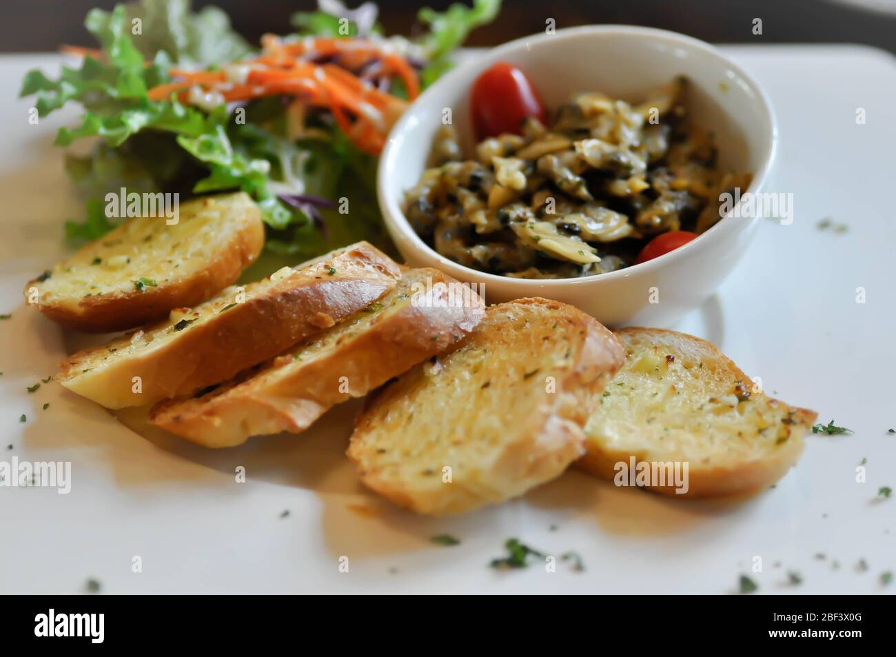 baked clams, baked garlic buttered clams and garlic bread Stock Photo ...