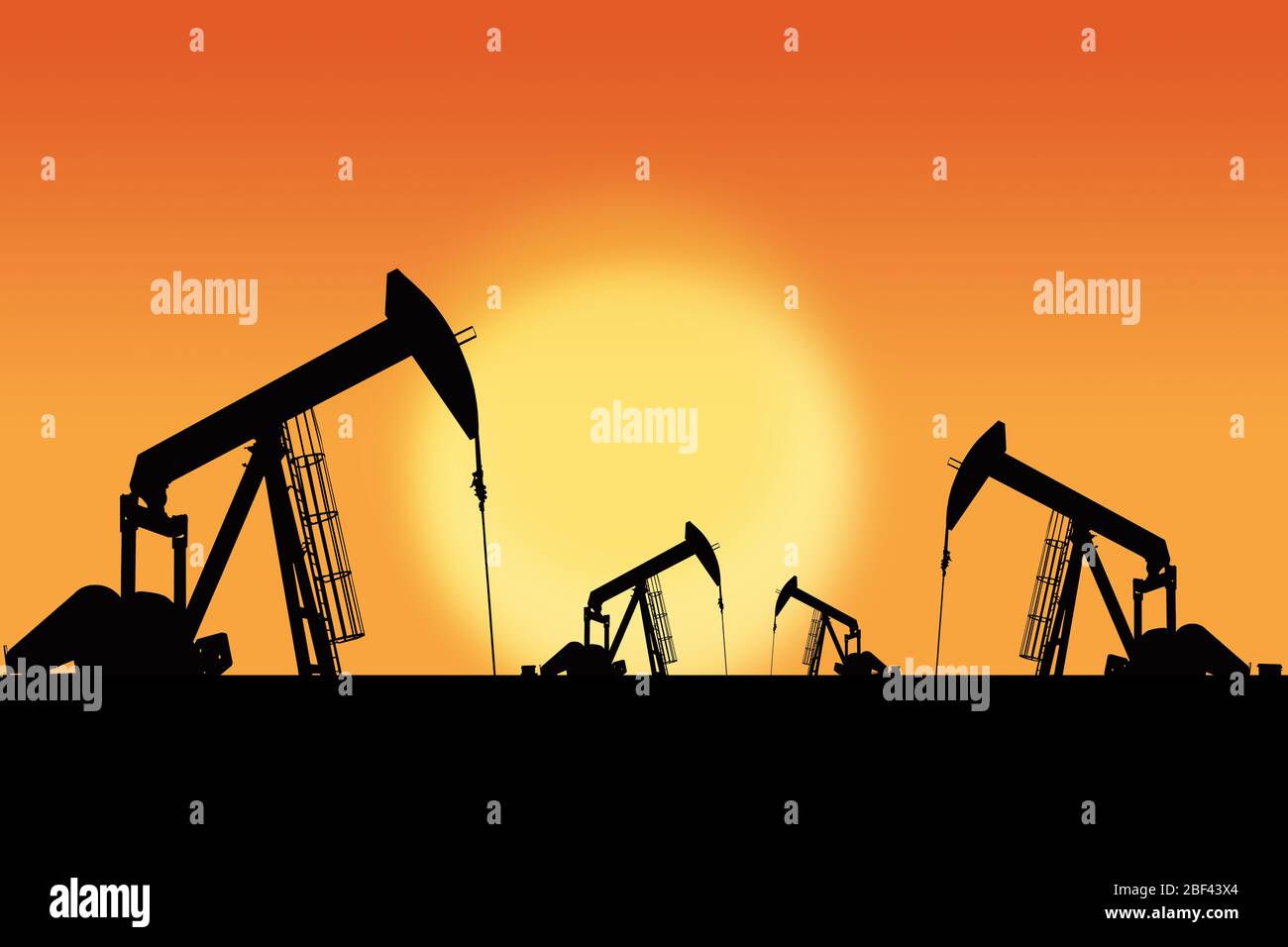 Rows of oil pumpjacks silhouette against a sunset sky with copy space ...