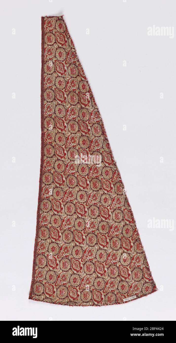 Fragment. Dense repeating pattern of silver leaves on a red background ...