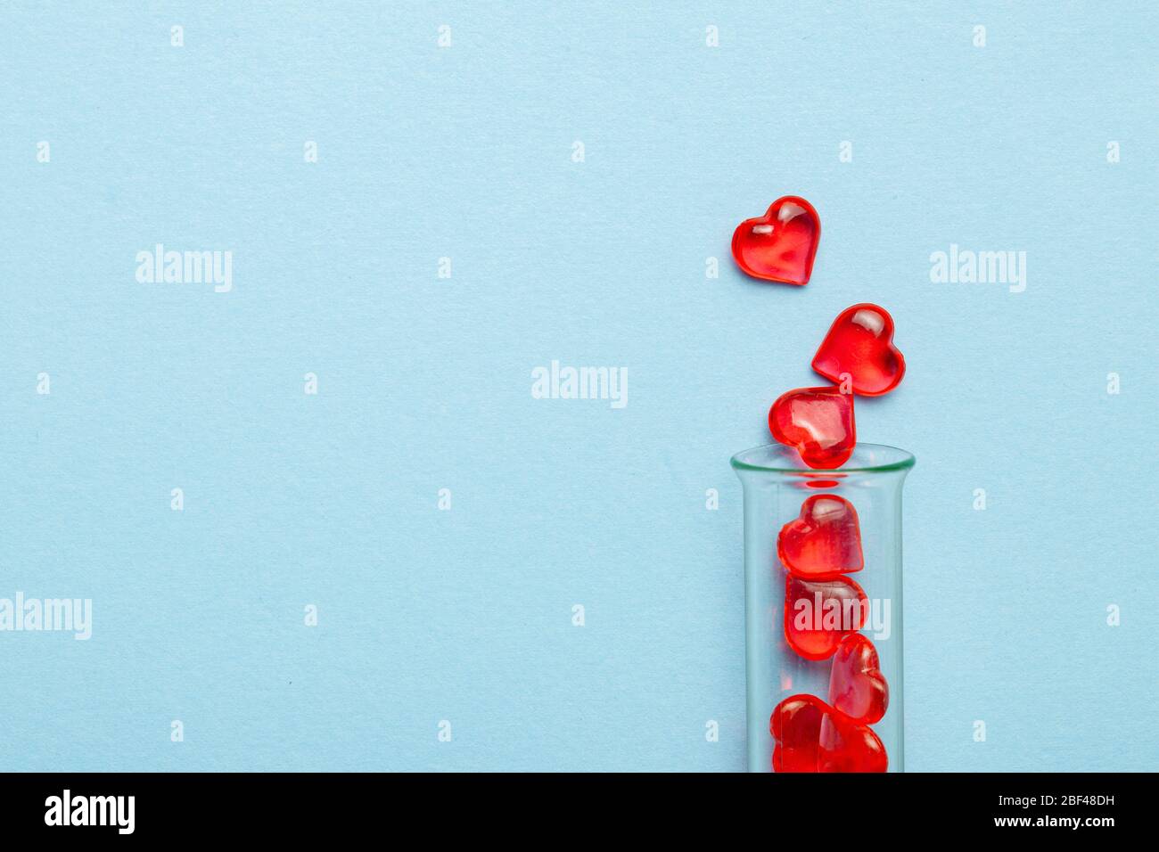 Hearts and test tube. Baby from tube vitro glass. Artificial ...