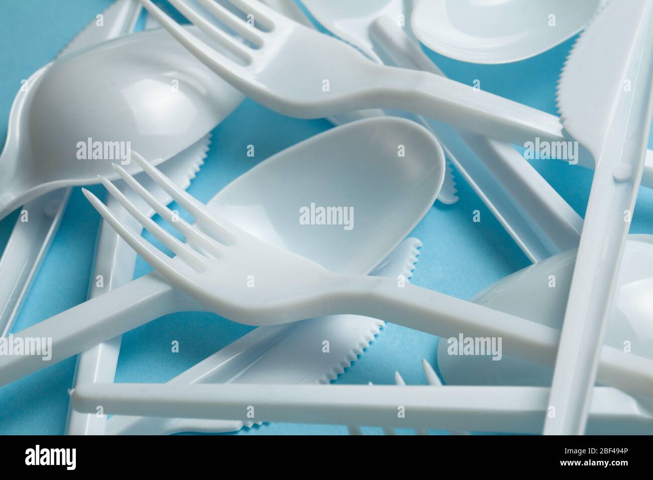 Plastic cutlery, forks, spoons and knives. Pollution of the environment ...