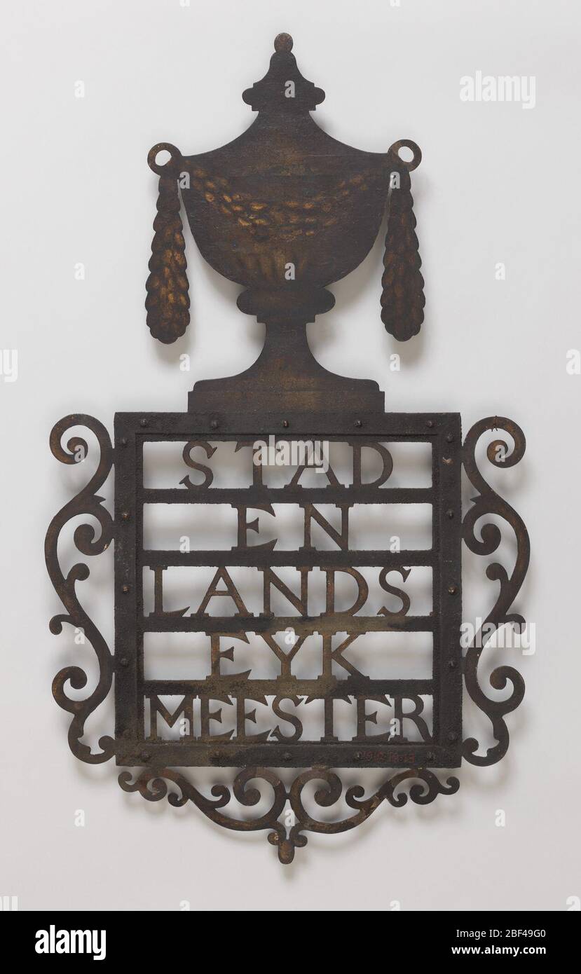 Sign. A metal sign. At center, a square with openwork lettering: STAD ...