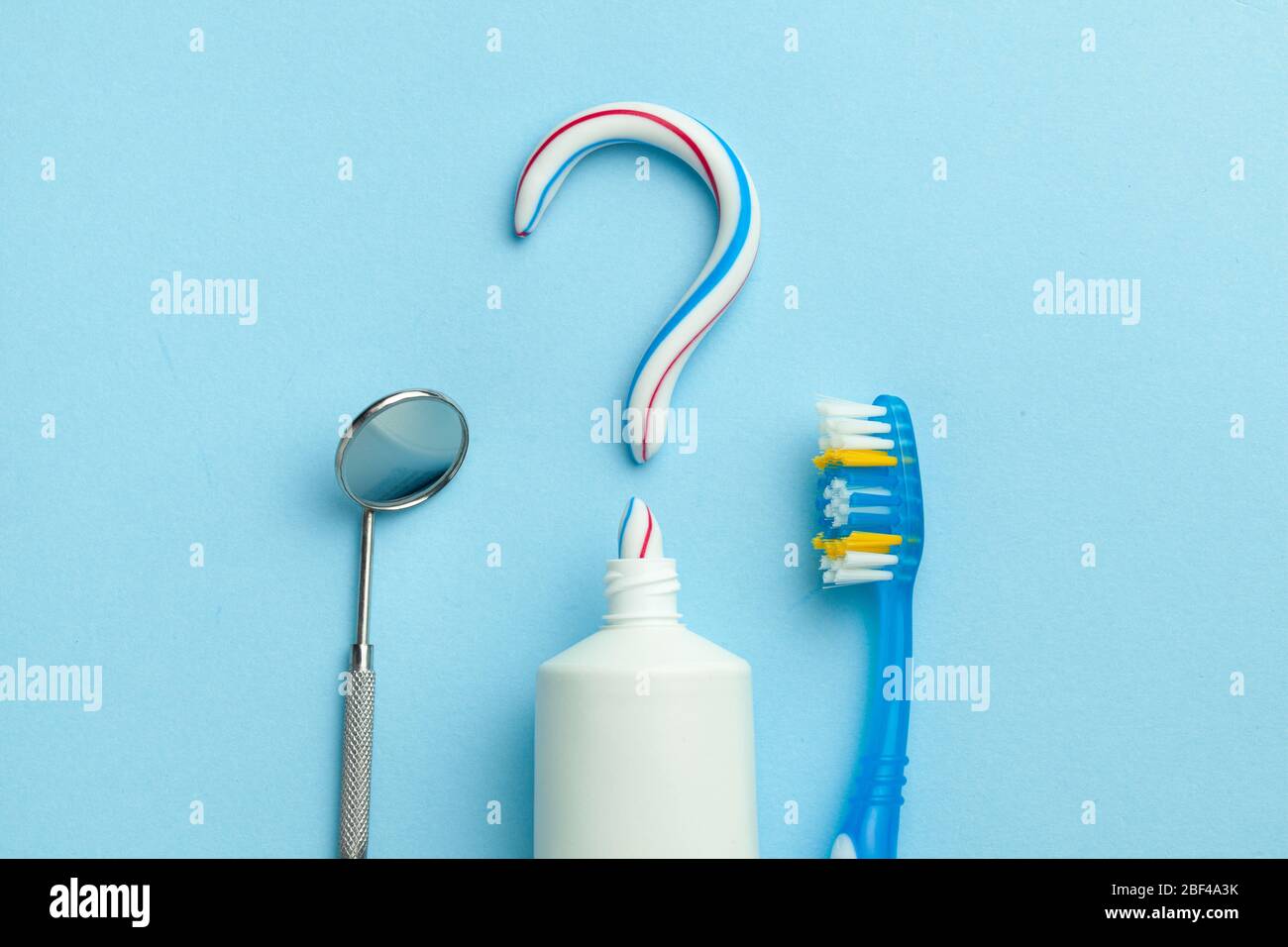 Question mark from toothpaste. Tube of colored toothpaste and ...