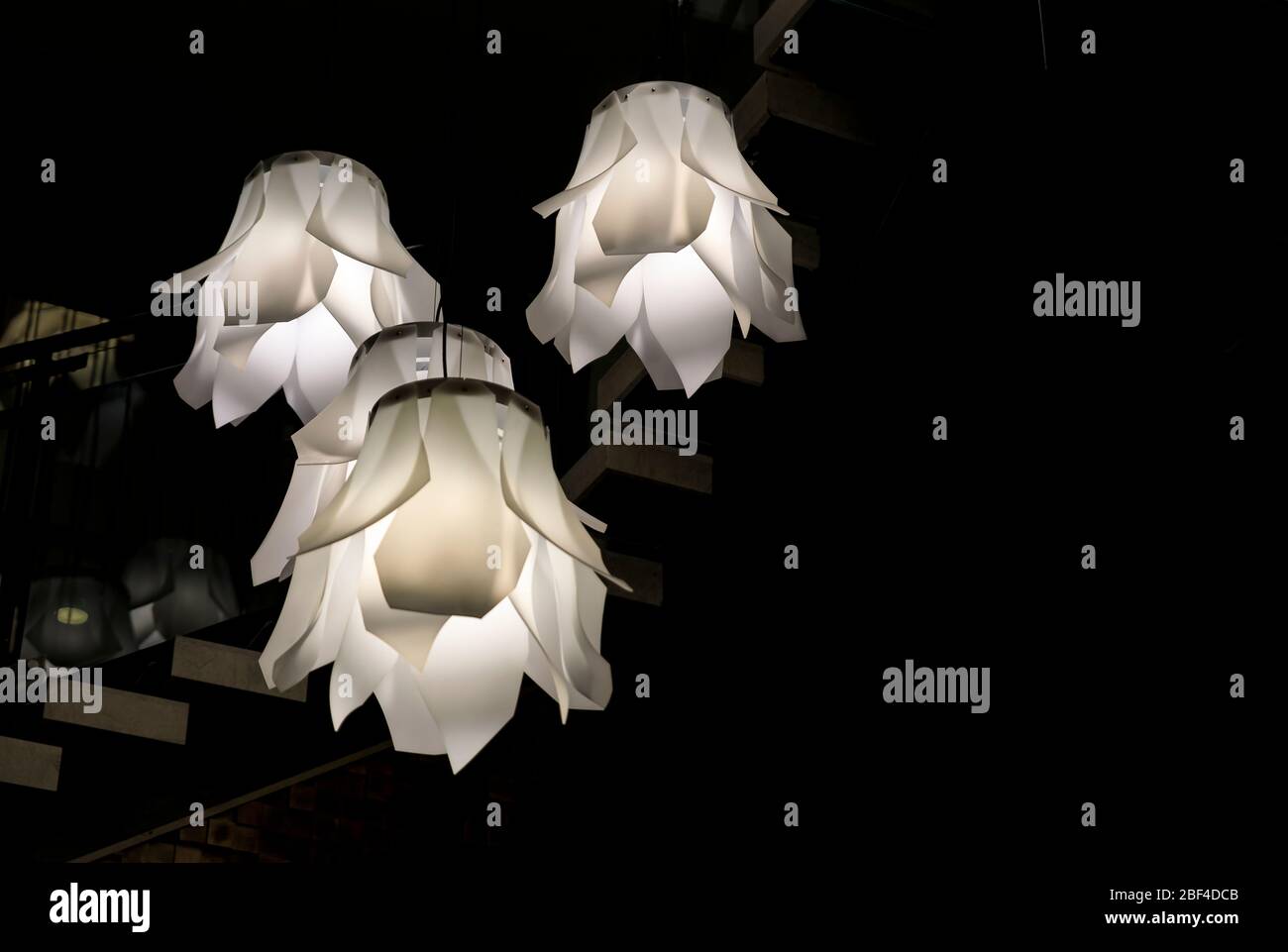 Modern opaque white abstract floral shaped light fixtures hanging from ...