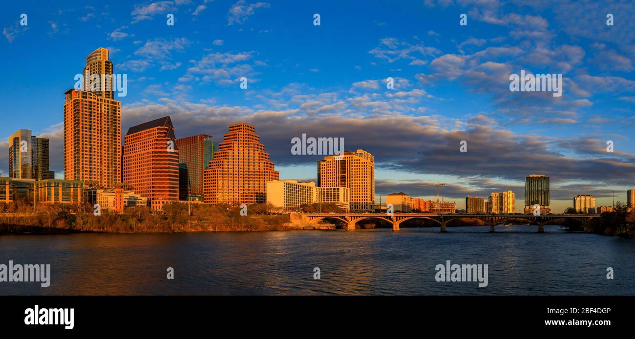Panorama with downtown high-rises reflecting sunset golden hour light ...