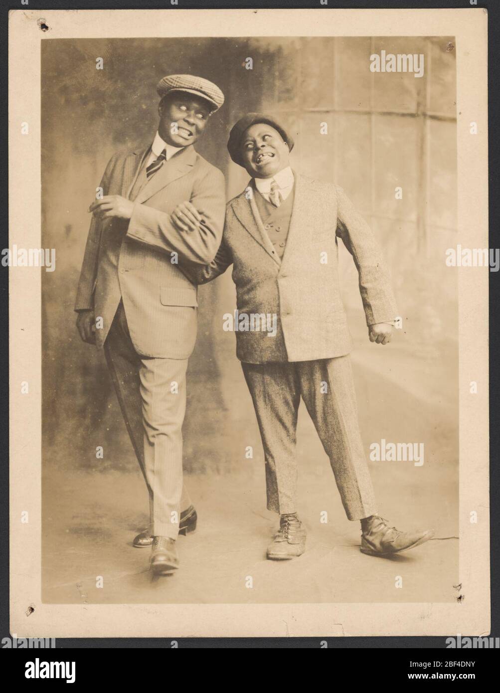 Photograph of two men linking arms. A black and white photograph of two ...