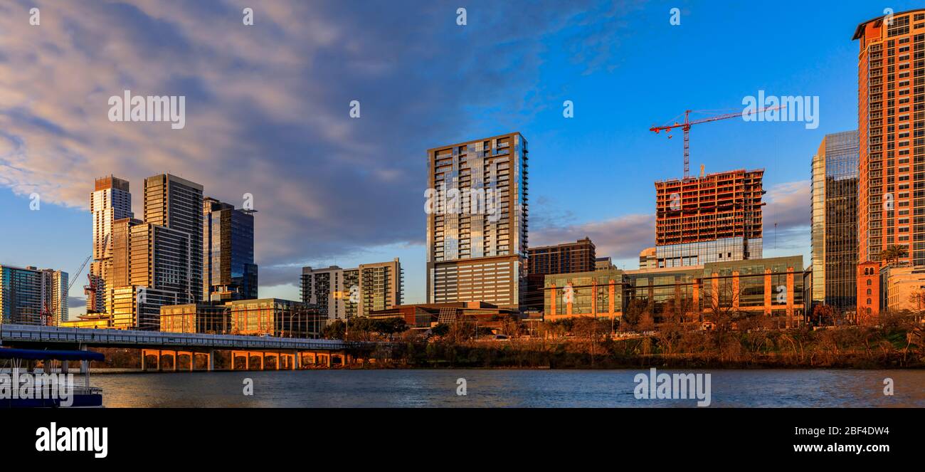 Panorama with downtown high-rises reflecting sunset golden hour light ...