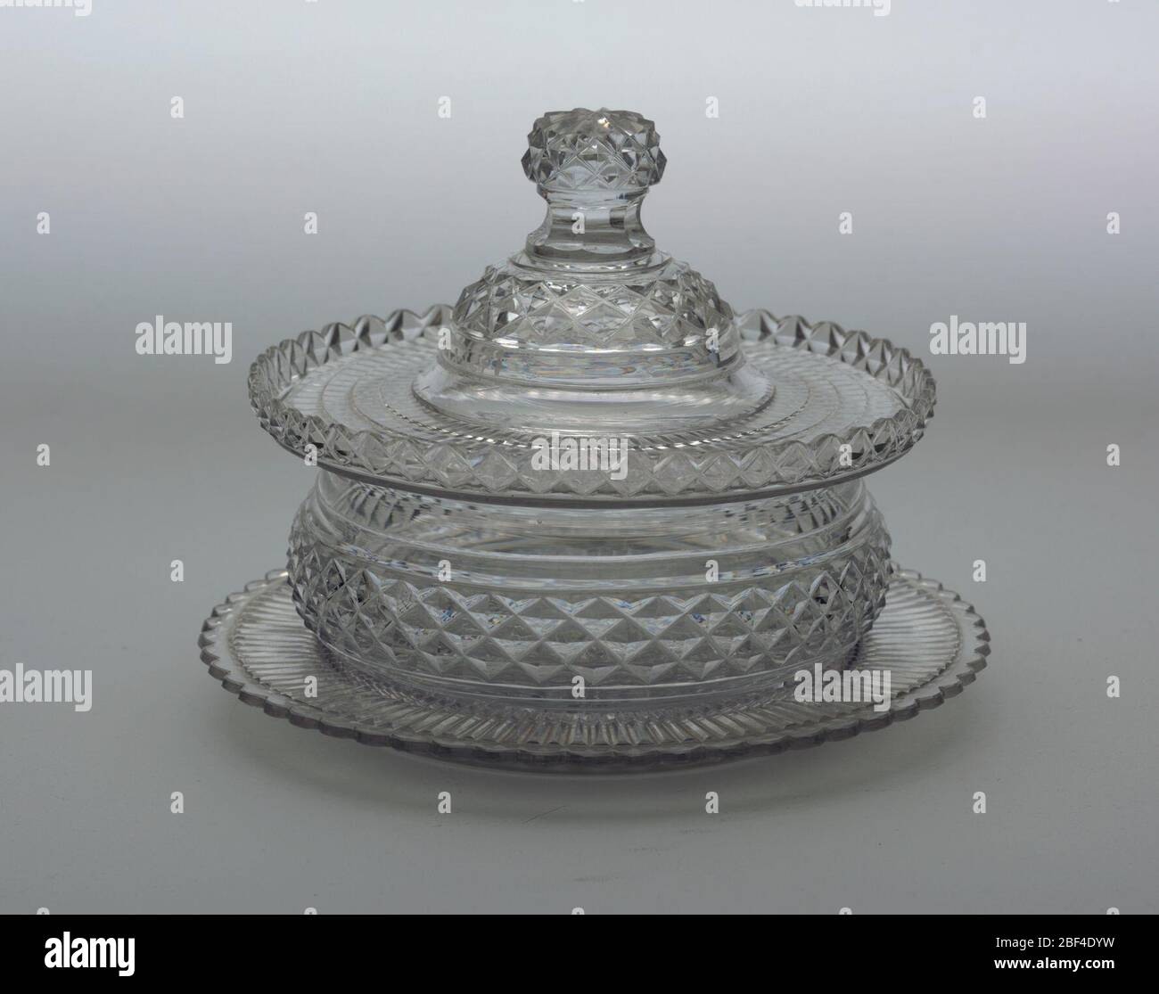 Dish with lid and stand. Circular waisted bowl has wide rim to hold ...