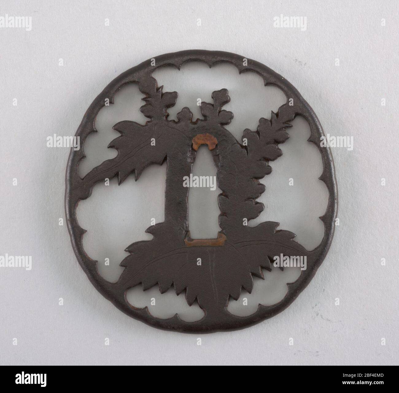 Tsuba. The tsuba is round in shape with ji sukashi (positive design ...