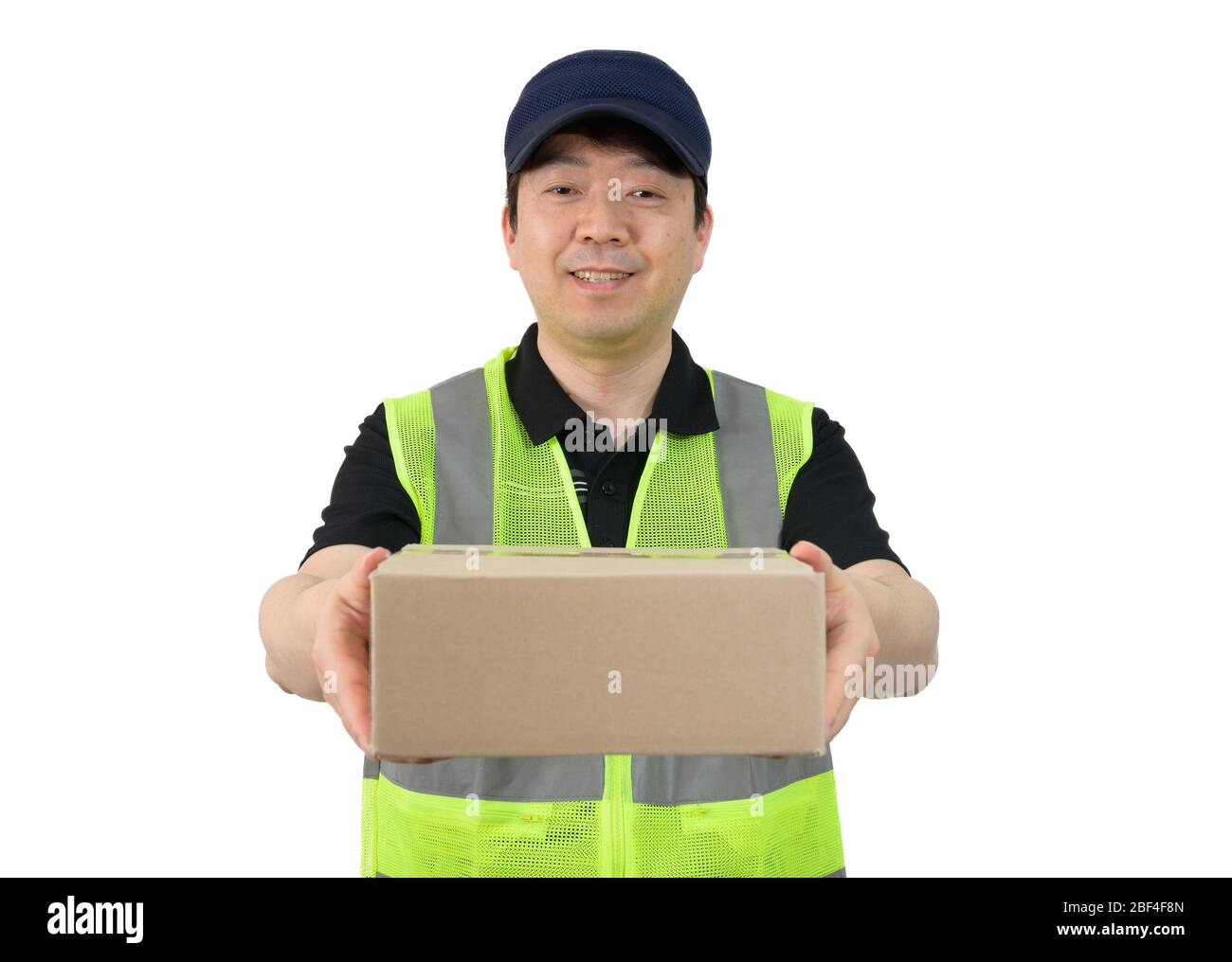 smiling delivery man holding a big parcel isolated on white background ...
