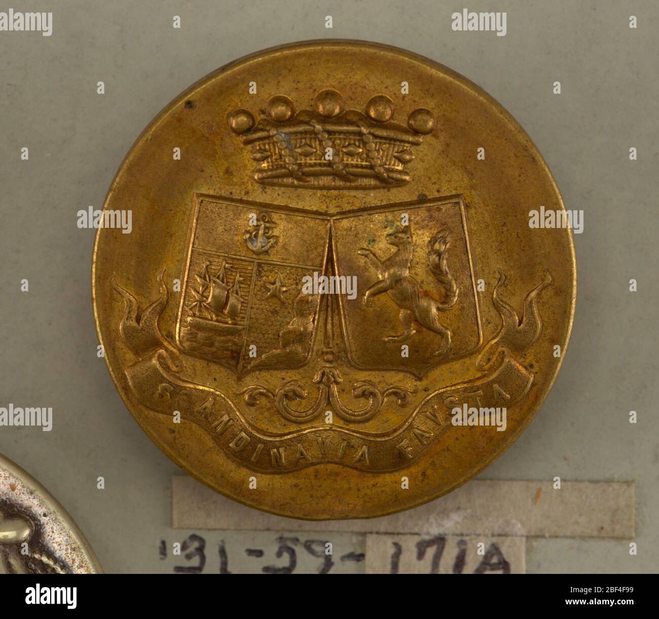 Button. Flat button showing ornament of two shields with heraldic ...