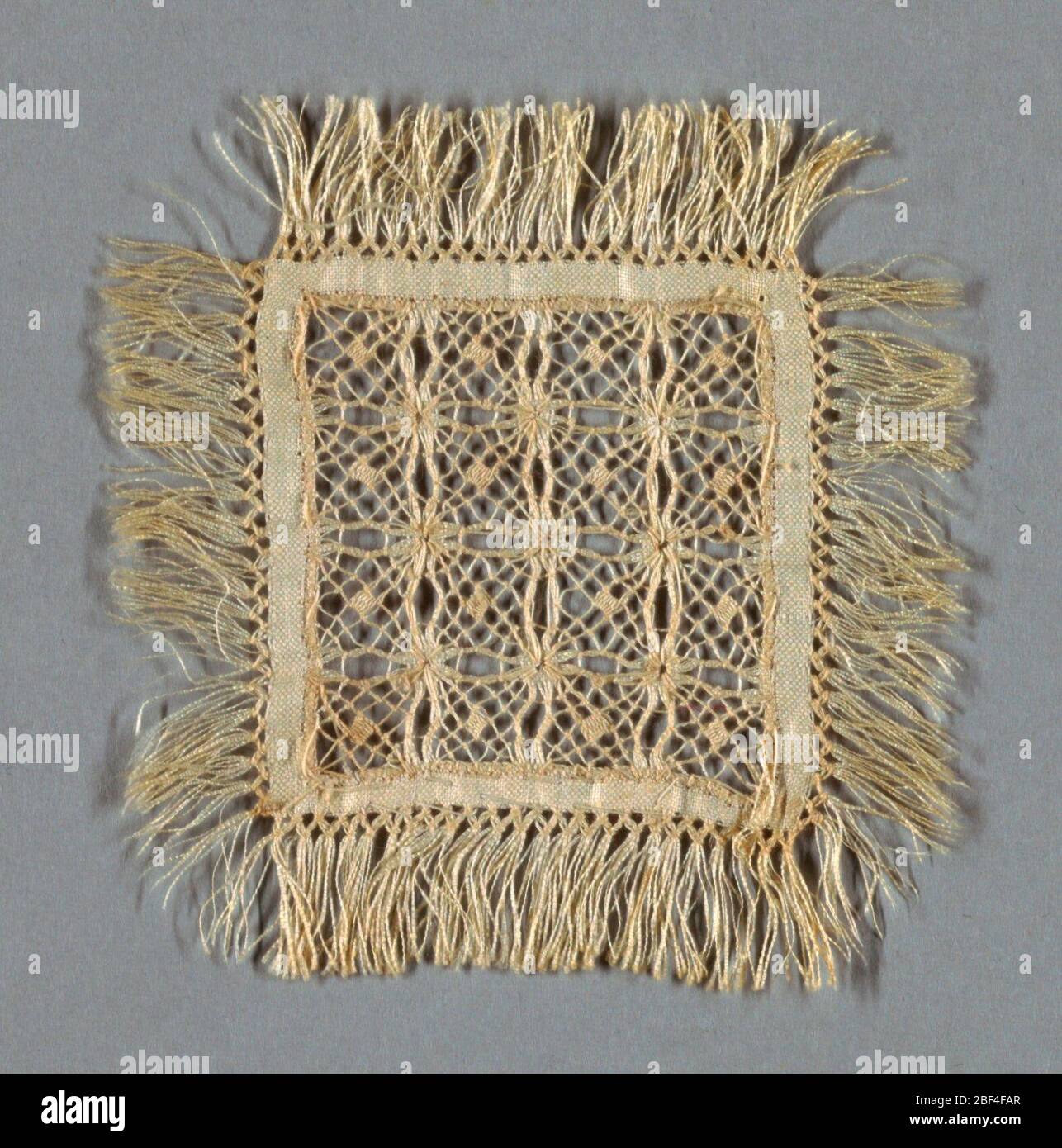 Sample. Square of fringed linen with center portion ornamented with ...