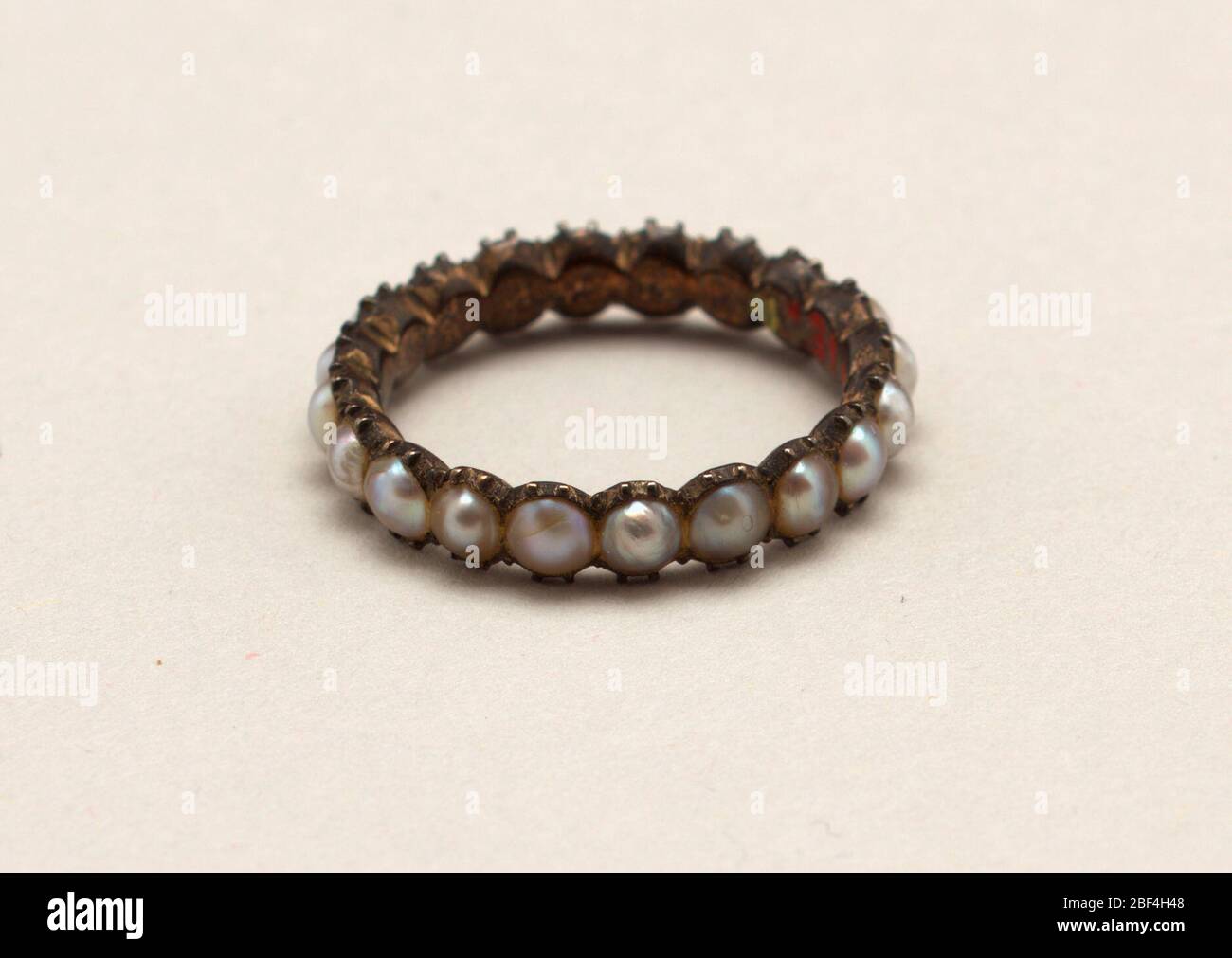 Ring. Circle of pearls set in gold band Stock Photo - Alamy