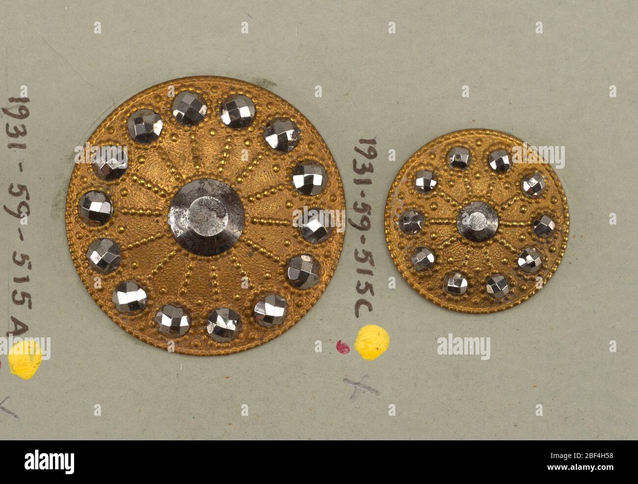 Buttons. brass buttons with cut steel knobs set in wheel-shaped ...