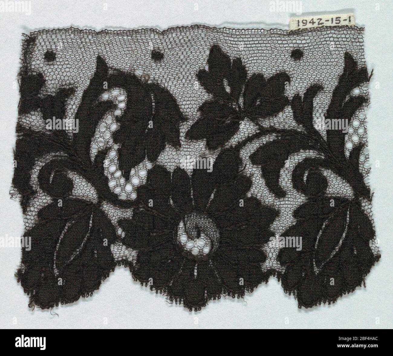 Fragment. Black Spanish blonde lace with handrun pattern of flowers and ...
