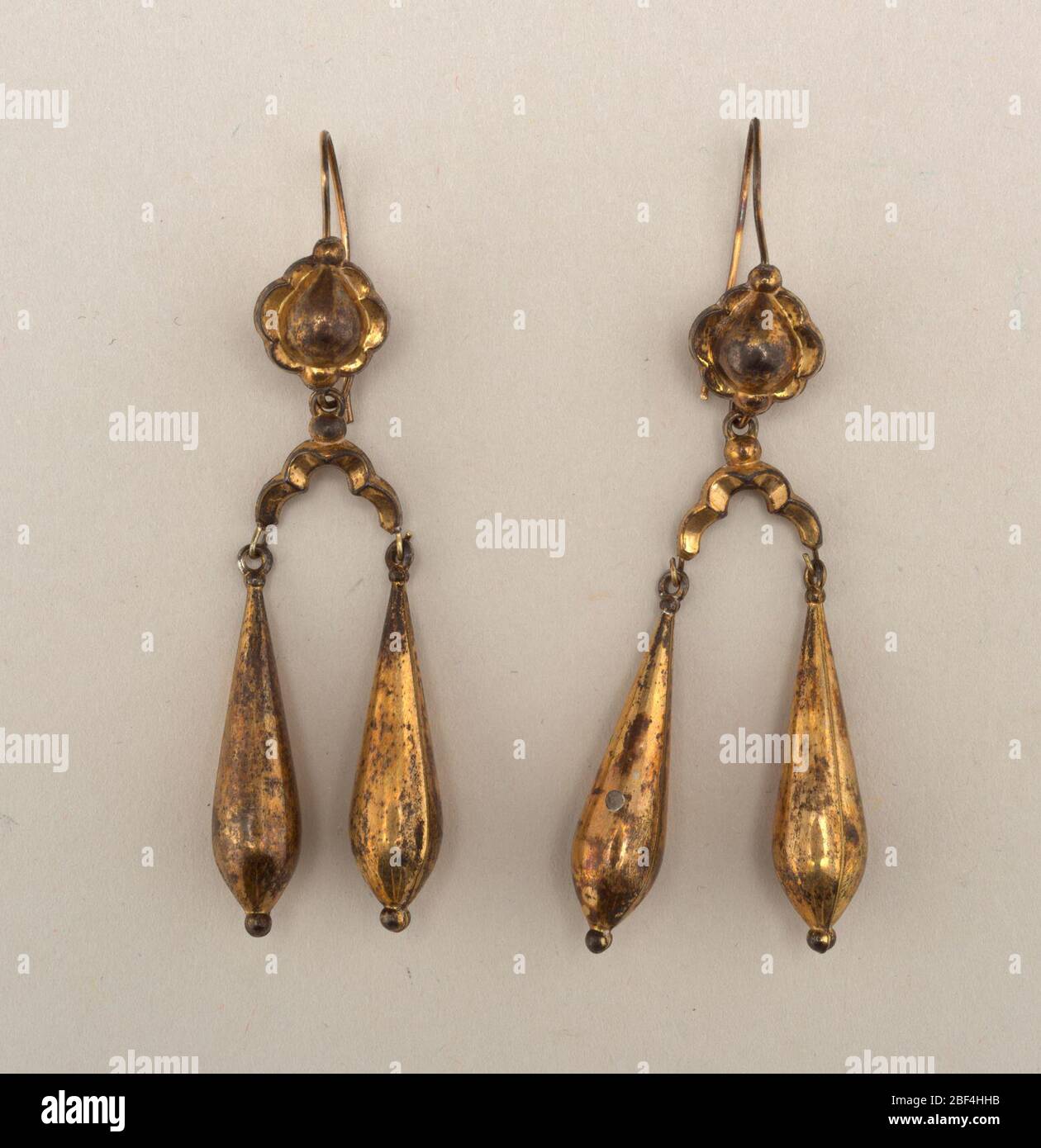 Earring. Each consists of two parts. A) and B) are upper parts, faced ...