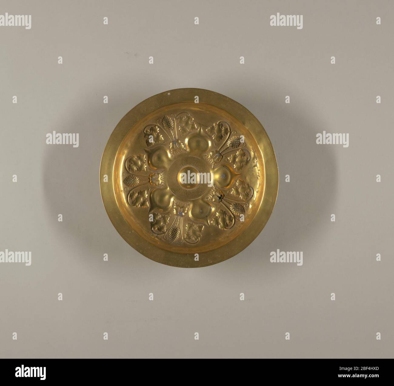 Dish. Deep round dish with narrow shallow rim; bottom decorated with ...