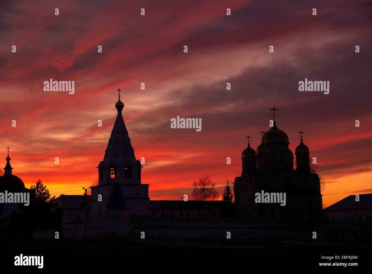 The black silhouette of the monastery against the bright sunset sky ...