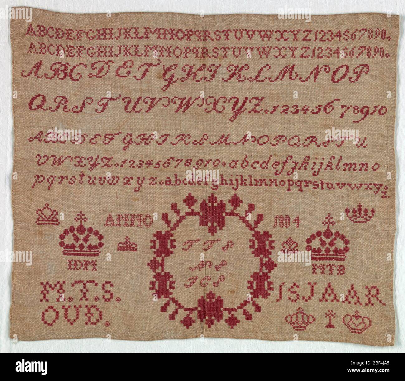 Sampler. Six alphabets, numerals, crowns, monograms. Signed "M.T.S. 15 ...