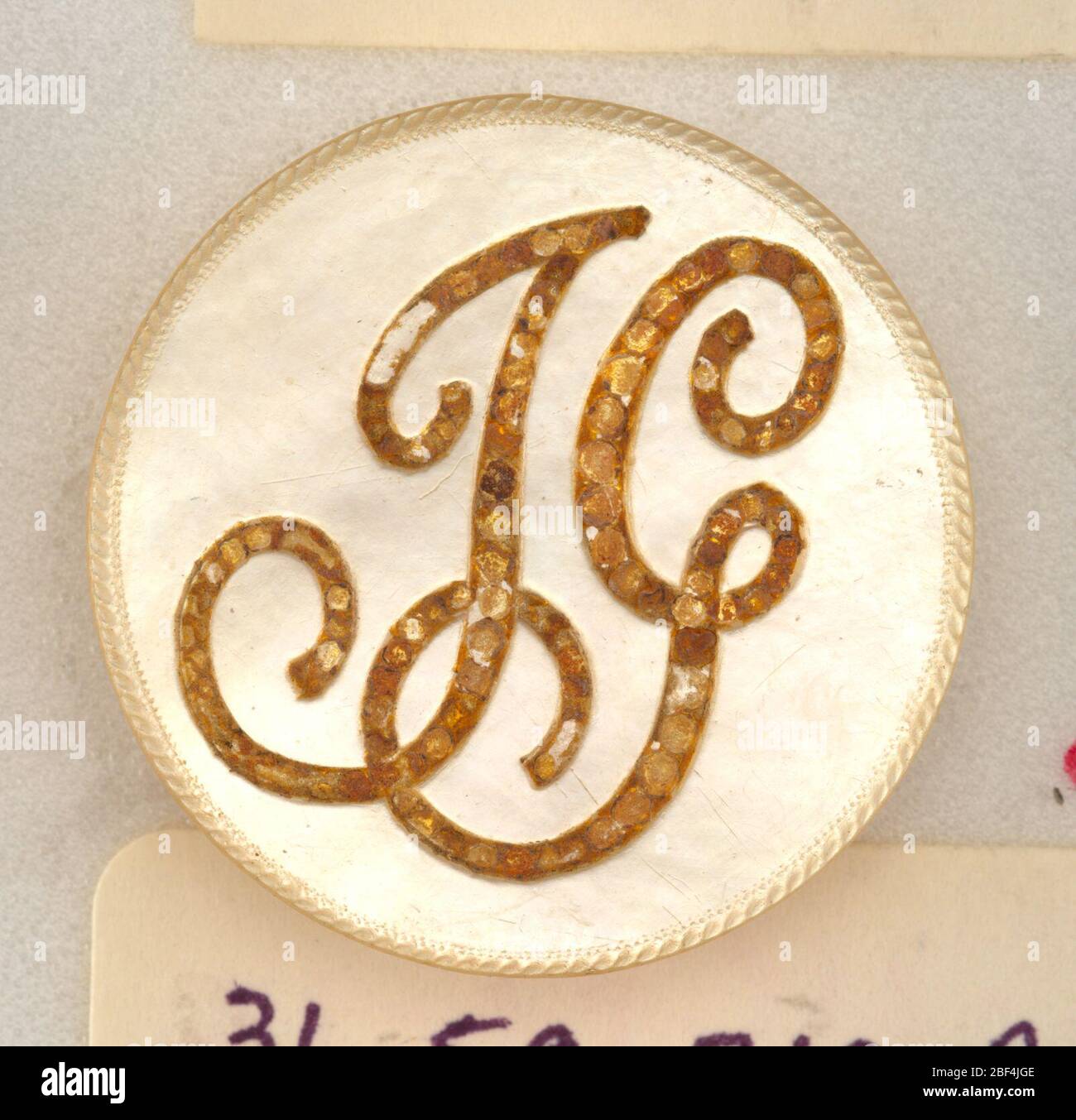 Button. Button of pearl shell carved in design of two initials: "J.G ...