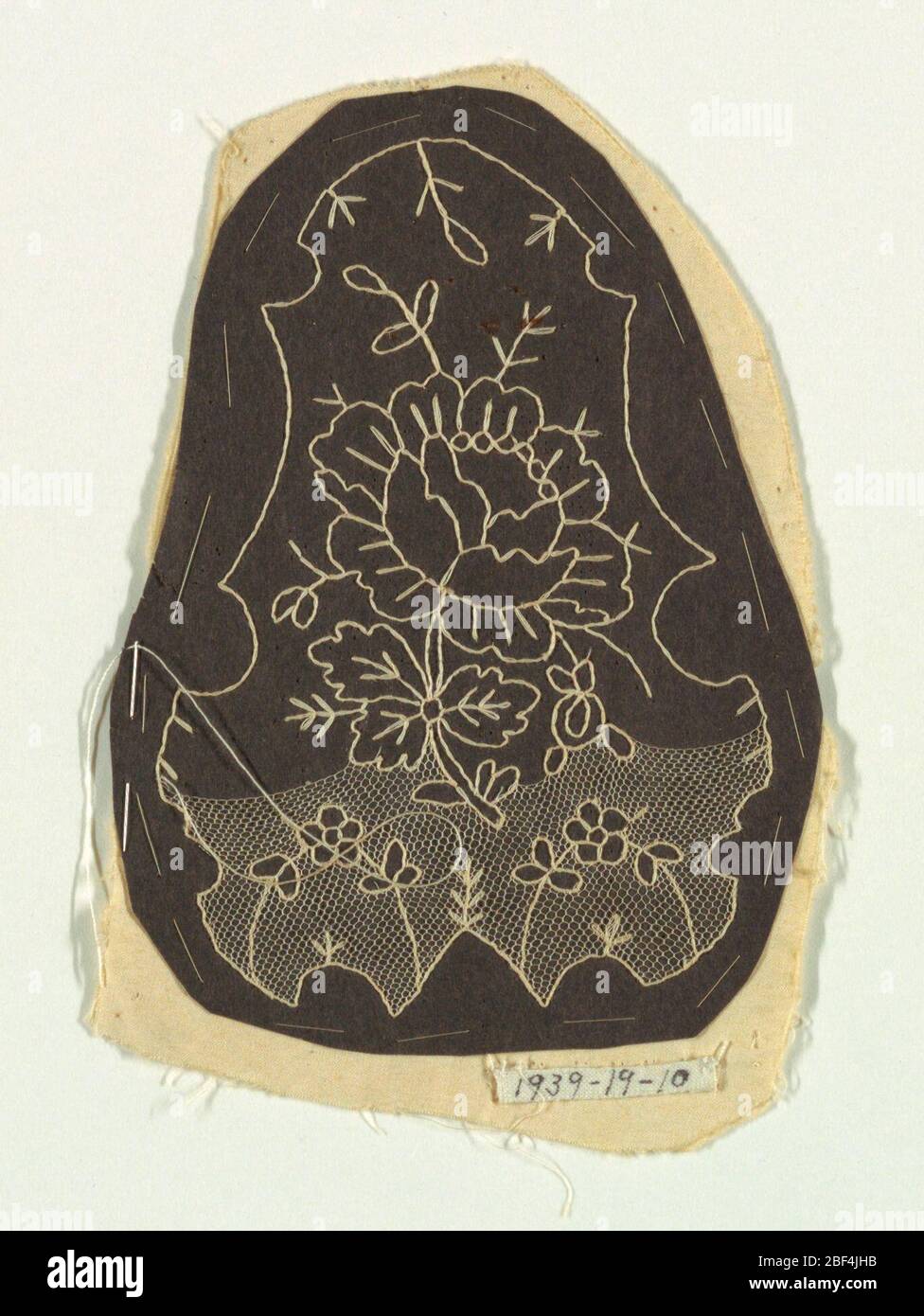 Pattern with uncompleted lace. Outlining thread is couched on pattern ...