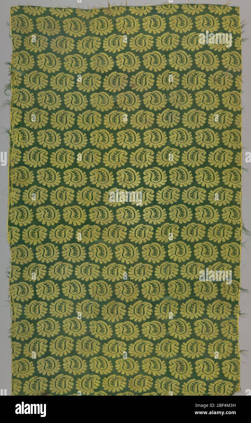 Textile. Yellow-green damask with an allover pattern of asymmetrical ...