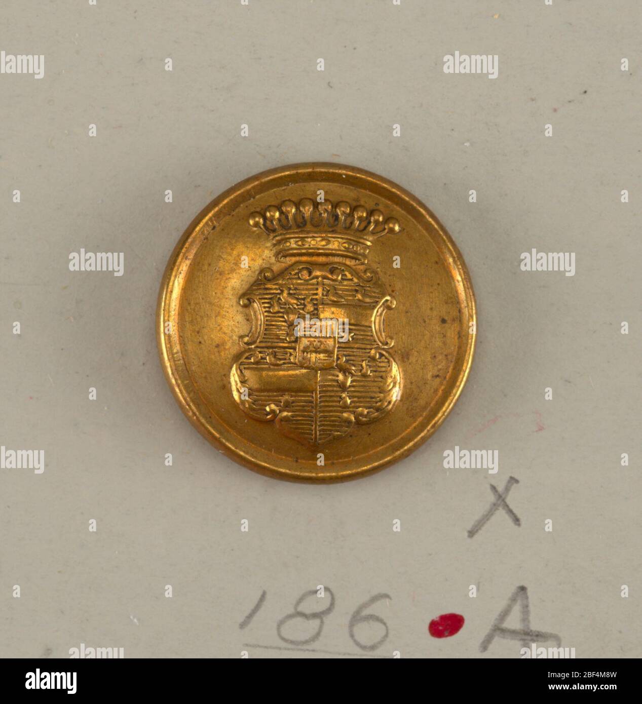 Button. Button showing shaped shield with coat of arms under a crown ...