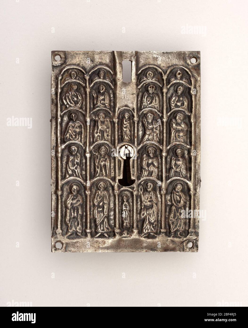 Lock and key. Rectangular cover plate depicting a series of robed ...