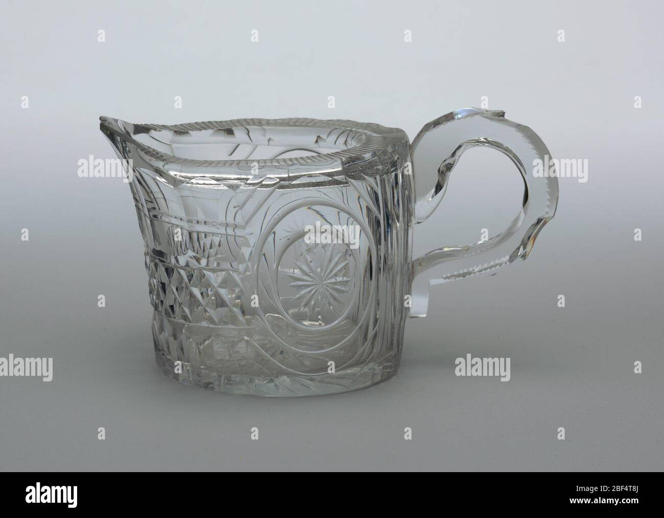 Jug. Oval straight-sided body with extended pouring and in-turned top ...